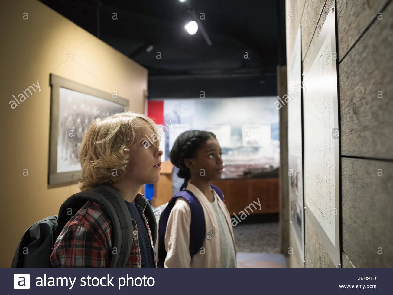 Two girls reading a poster hi-res stock photography and images - Alamy