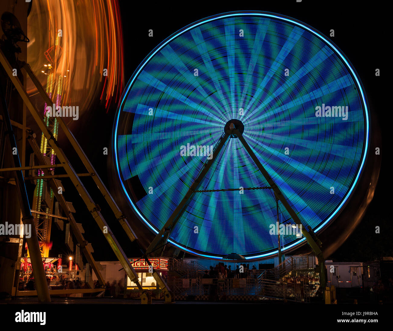 Popular rides at night at the county fair Stock Photo - Alamy