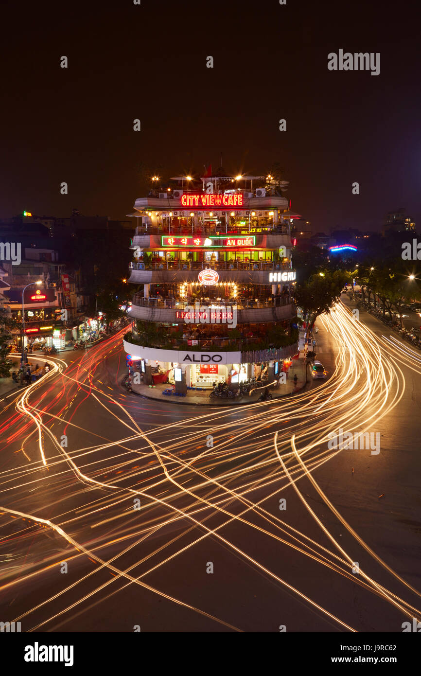 Bars, restaurants and lights from traffic at busy intersection by Hoan ...
