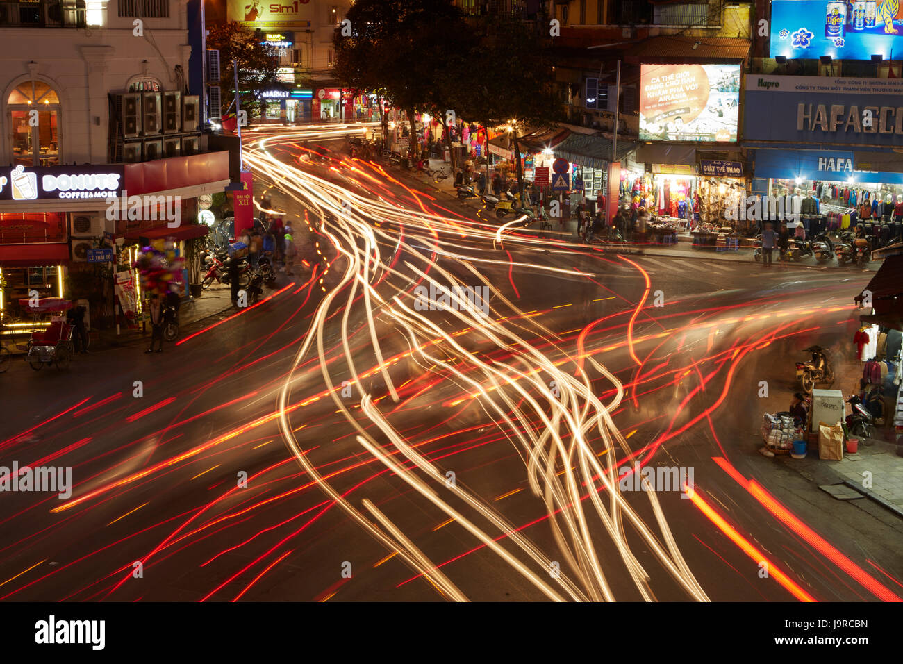 Lights from traffic at busy intersection by Hoan Kiem Lake and Old ...