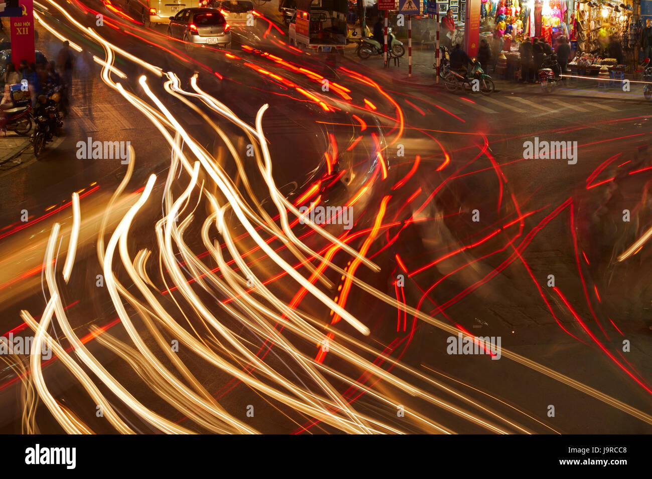 Lights from traffic at busy intersection by Hoan Kiem Lake and Old ...