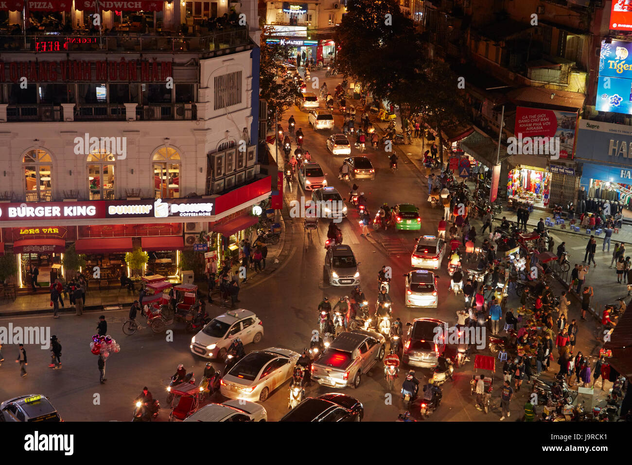 Crazy traffic at night at busy intersection by Hoan Kiem Lake and Old ...
