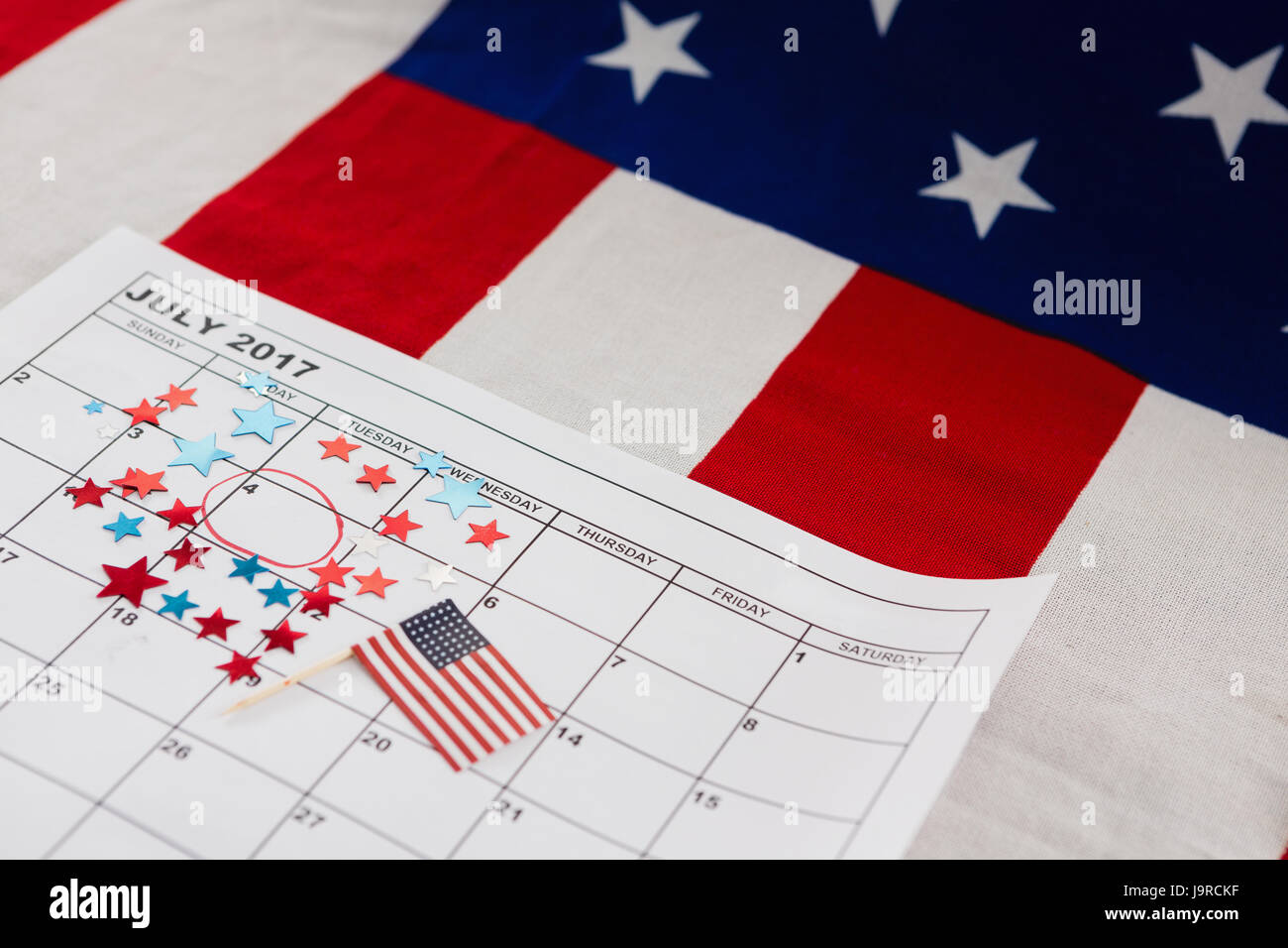 Calendar marked with star shape decoration and American flag with 4 th ...