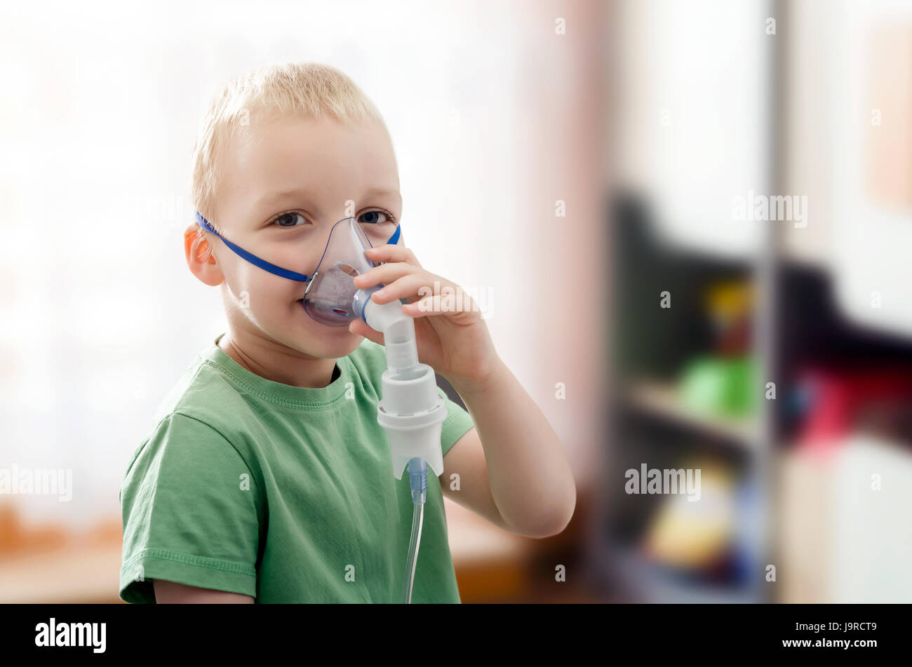 Boy making inhalation with nebulizer at home. child asthma inhaler ...