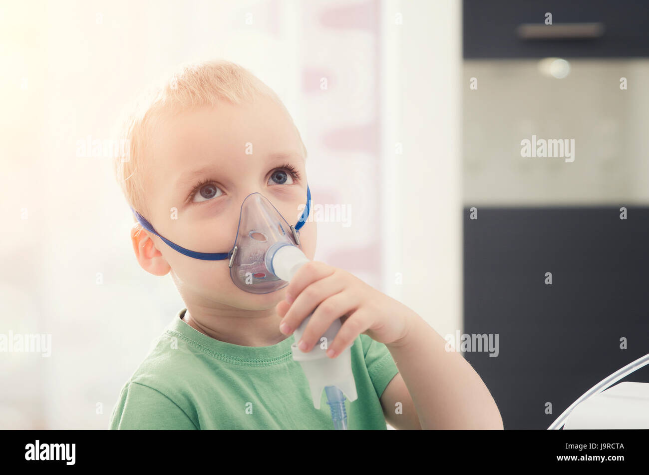 Boy making inhalation with nebulizer at home. child asthma inhaler ...