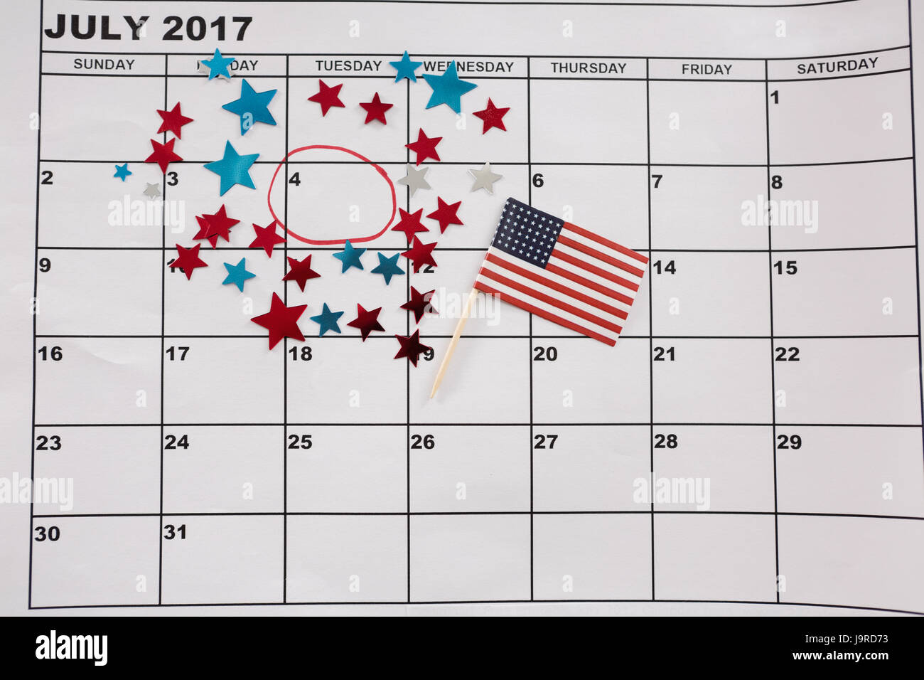 Calendar marked with star shape decoration and American flag with 4 th ...