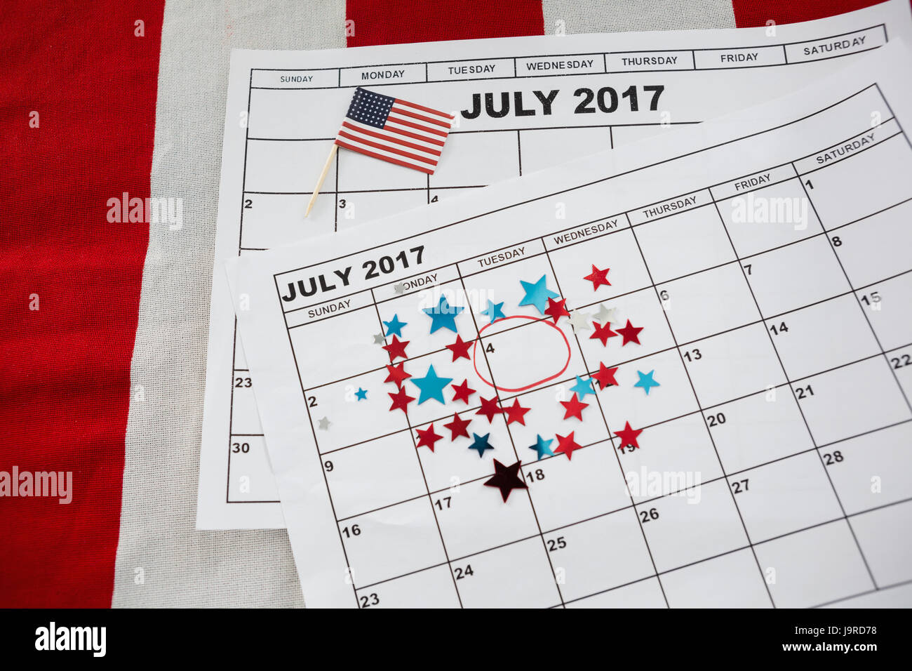 Calendar marked with star shape decoration and American flag with 4 th ...