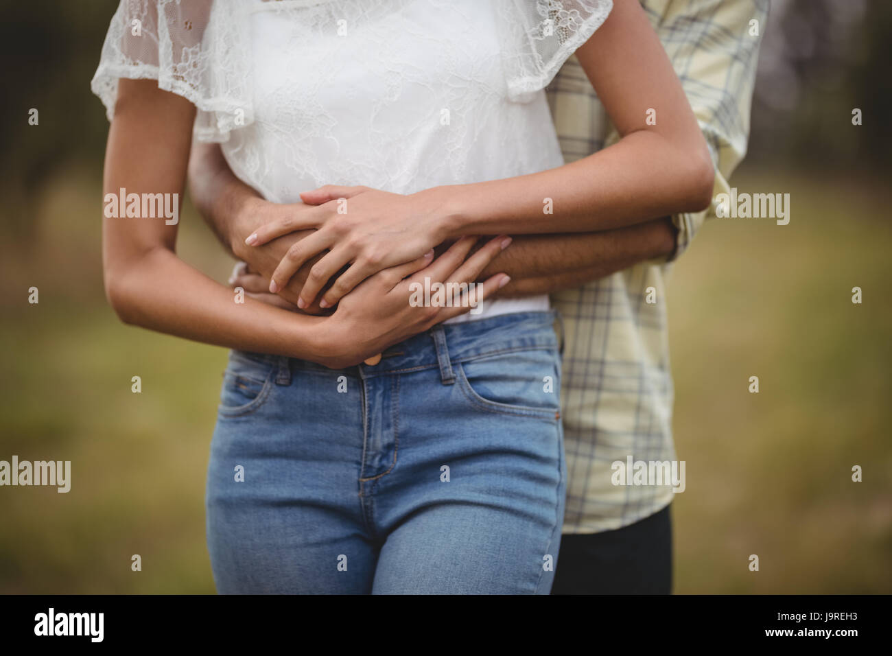 Mid section of couple embracing at olive farm Stock Photo - Alamy