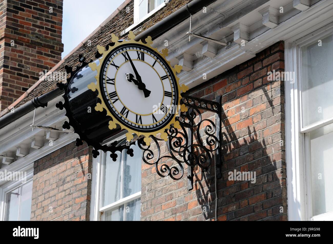 Clock hanging on building hi-res stock photography and images - Alamy