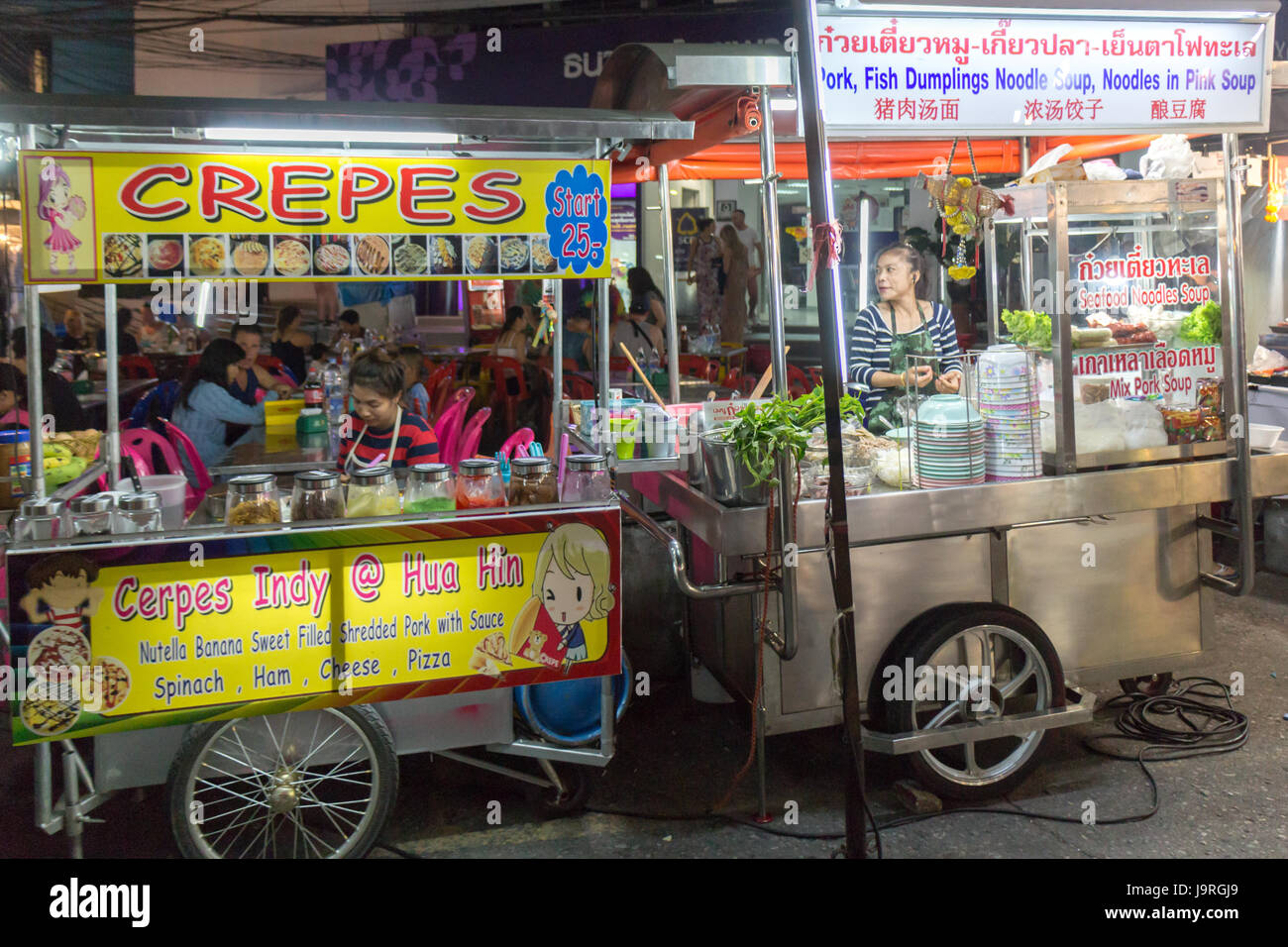 Mobile food stalls selling noodle soup and crepes on Hua Hin night ...