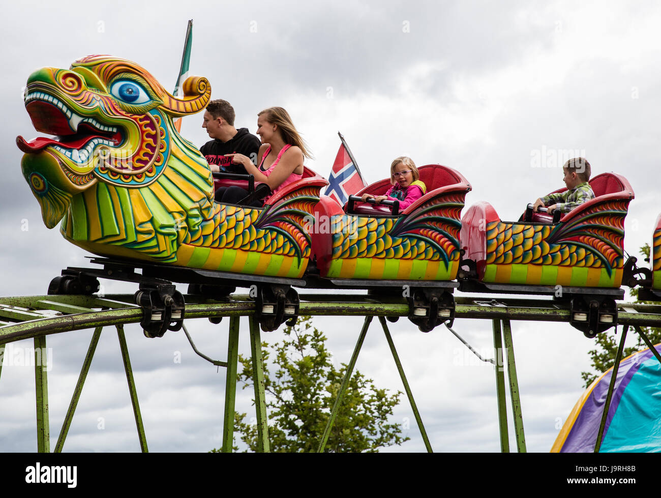 Riding a Chinese dragon at the county fair Stock Photo - Alamy