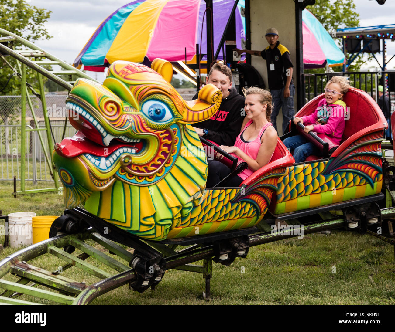 Riding a Chinese dragon at the county fair Stock Photo - Alamy