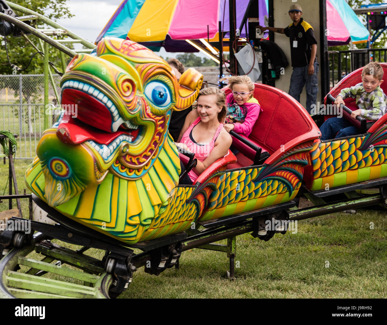 Riding a Chinese dragon at the county fair Stock Photo - Alamy