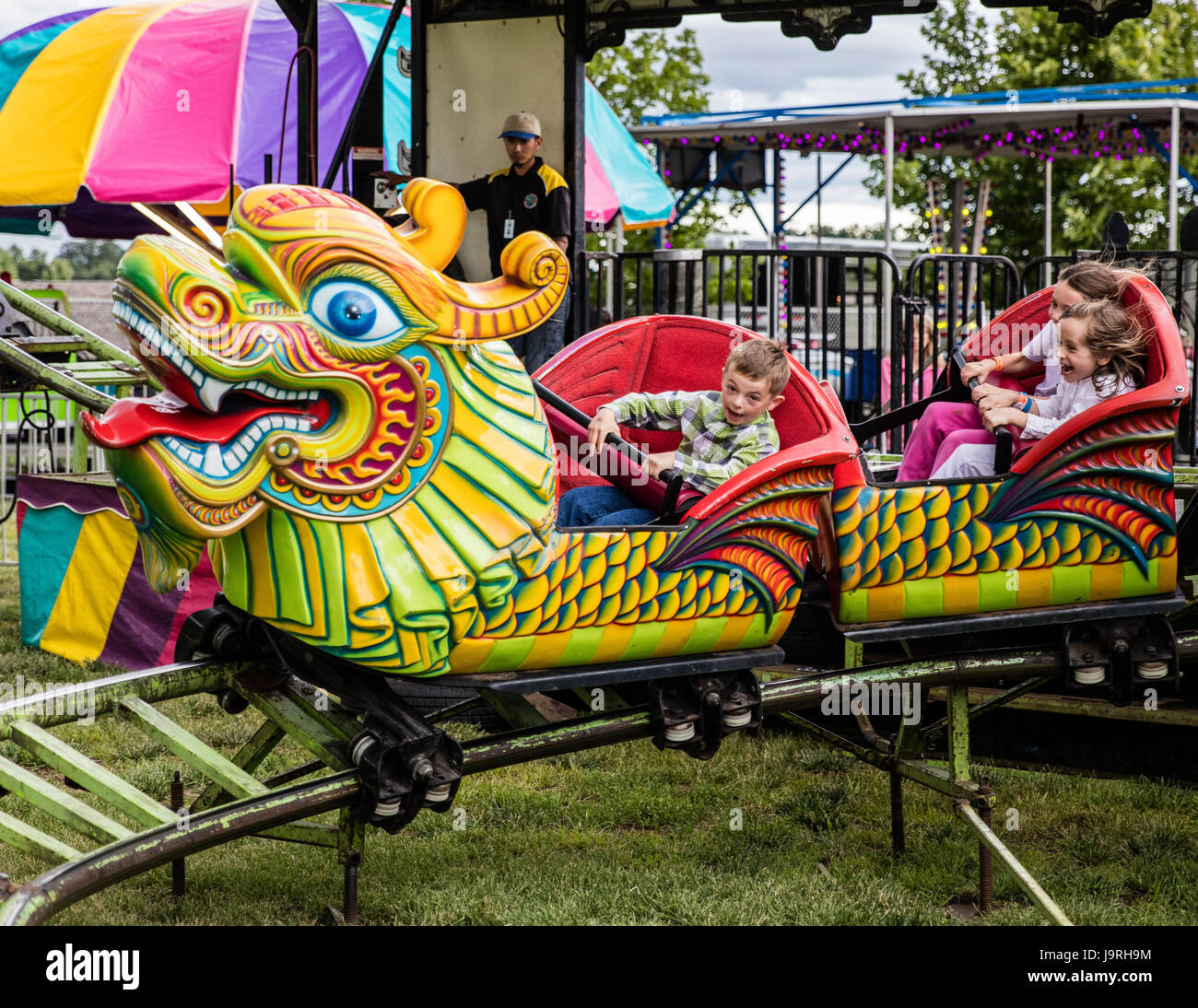 Riding a Chinese dragon at the county fair Stock Photo - Alamy