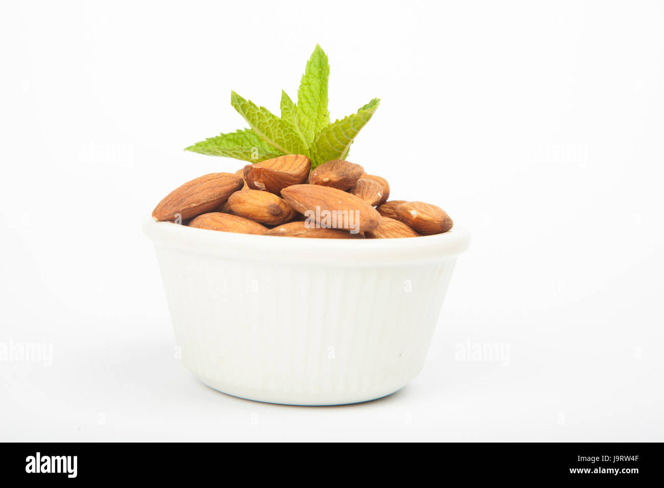 Many almonds isolated on white background Stock Photo - Alamy