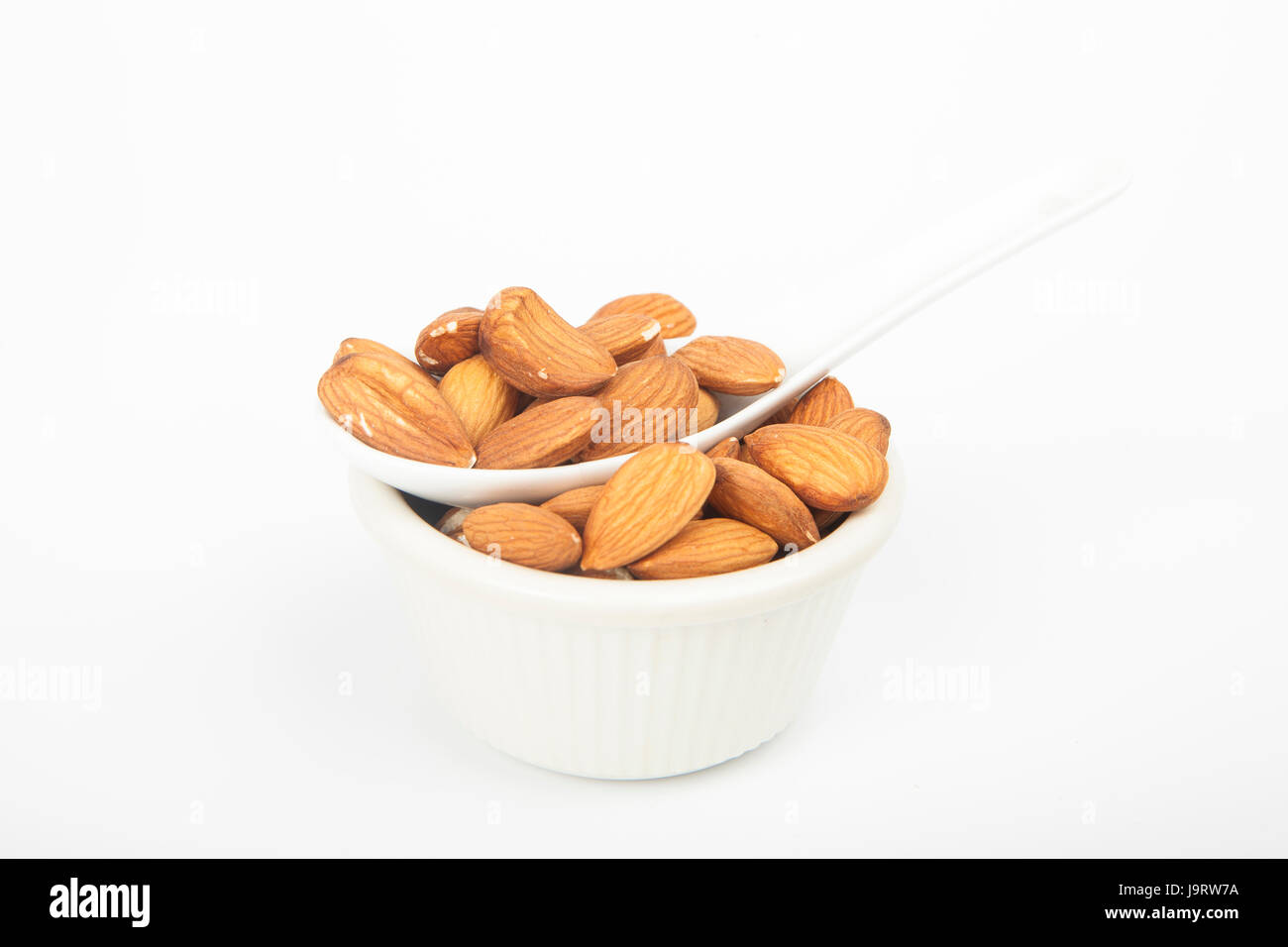 Many almonds isolated on white background Stock Photo - Alamy