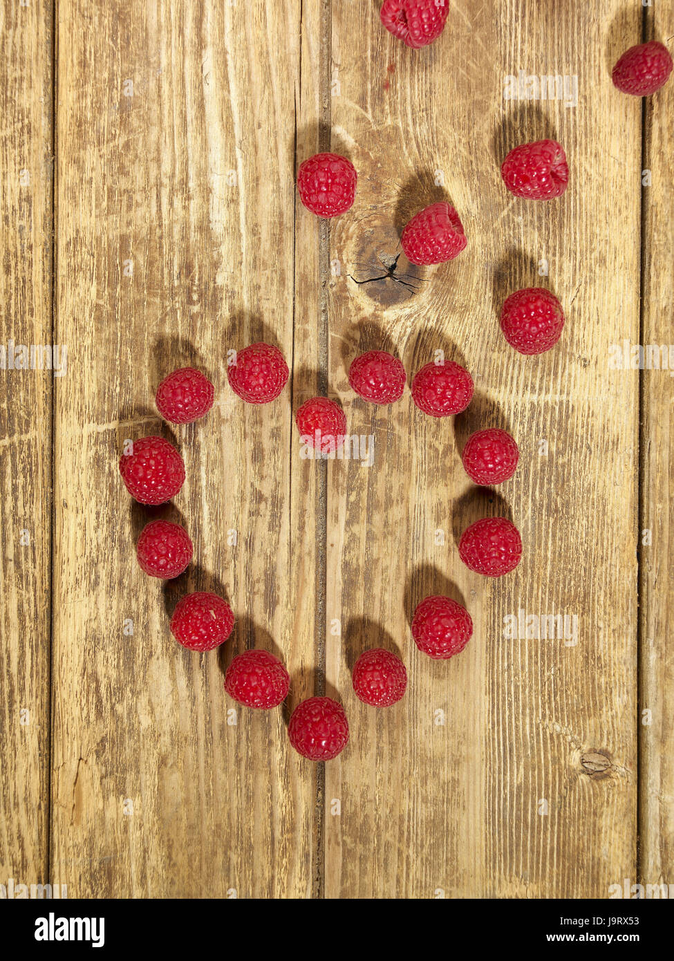 wooden wall,raspberries,heart form Stock Photo - Alamy