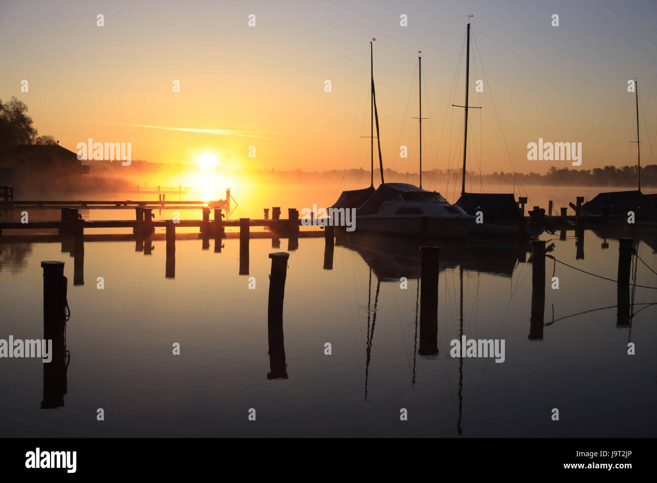 Germany,Bavaria,Upper Bavaria,Chiemgau,Lake Chiem,boats,sunrise,back ...