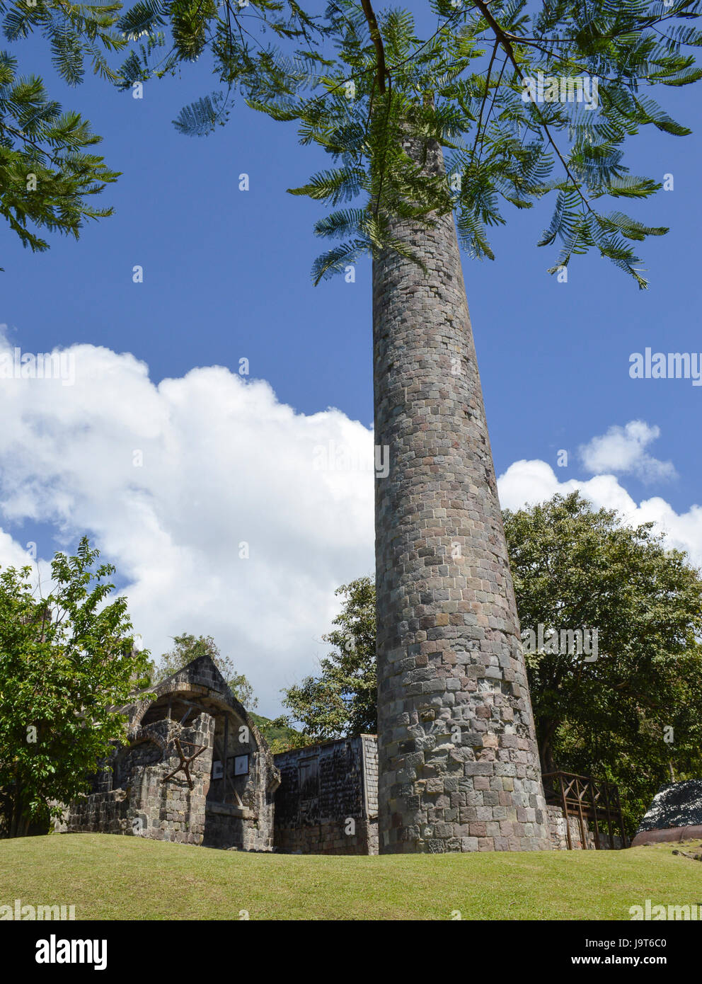 Standing at the foot of a tall historic stone tower Stock Photo - Alamy