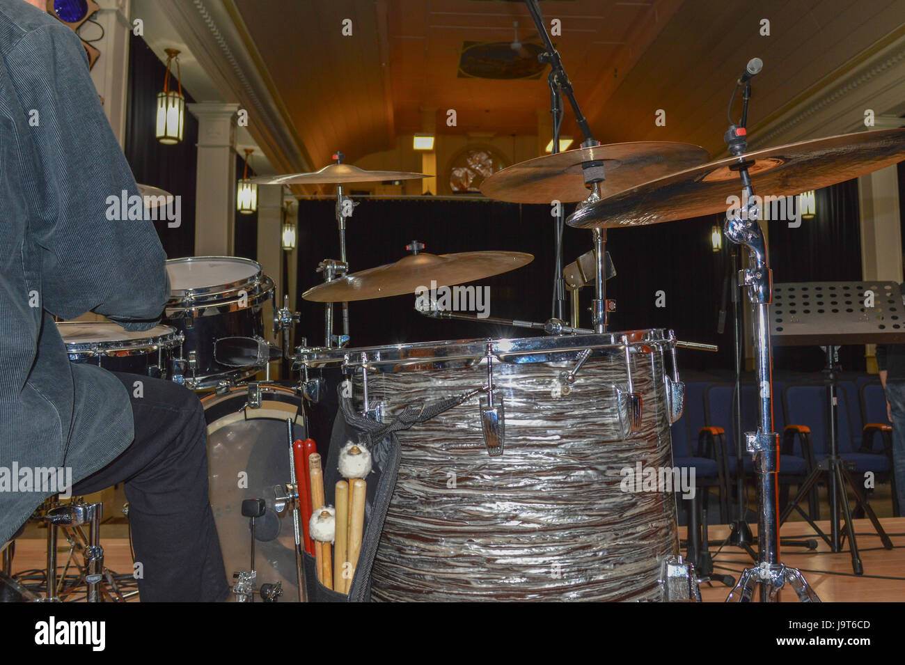 Drummer on the stage with his drum set ready to play Stock Photo - Alamy