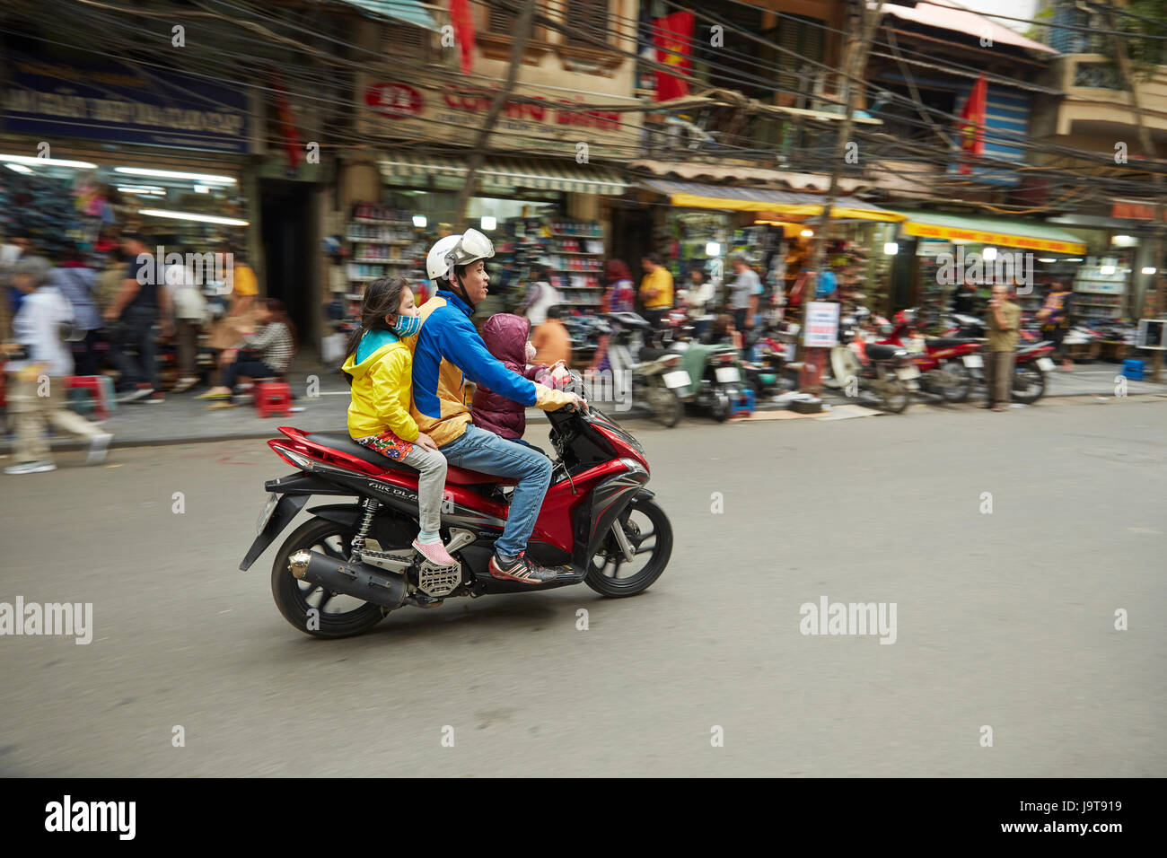Father and children on scooter, Old Quarter, Hanoi, Vietnam Stock Photo - Alamy