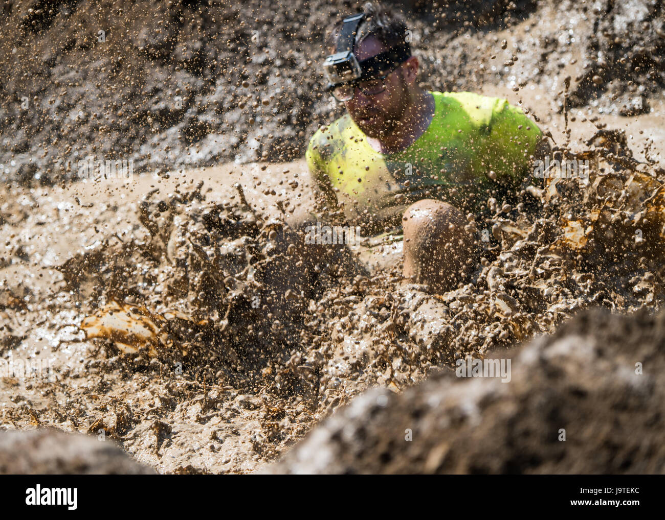 Waechtersbach, Germany. 3rd June, 2017. A participant slides into a mud ...