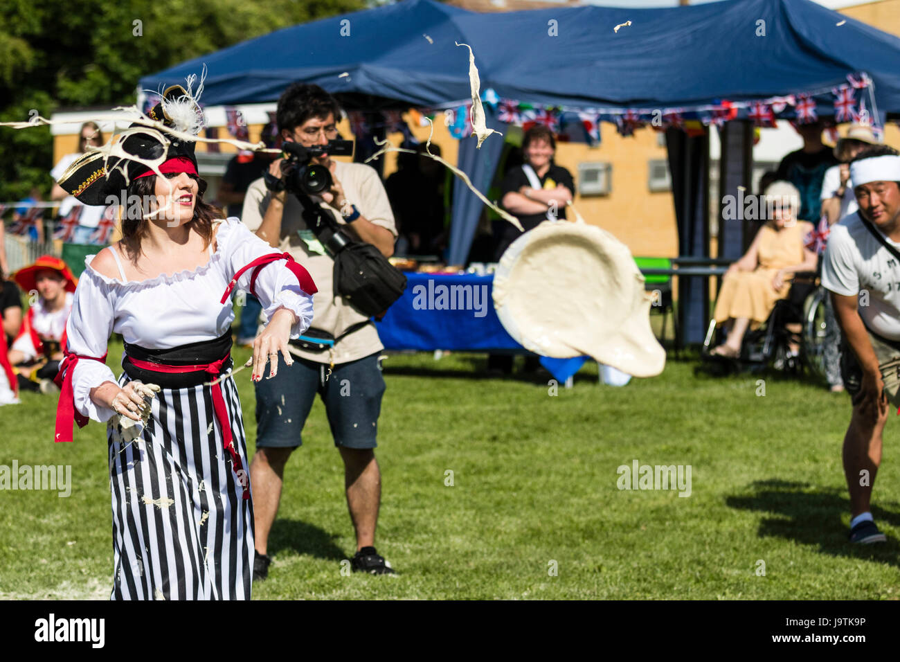 Team of people dressed as pirates throwing and getting hit by custard ...