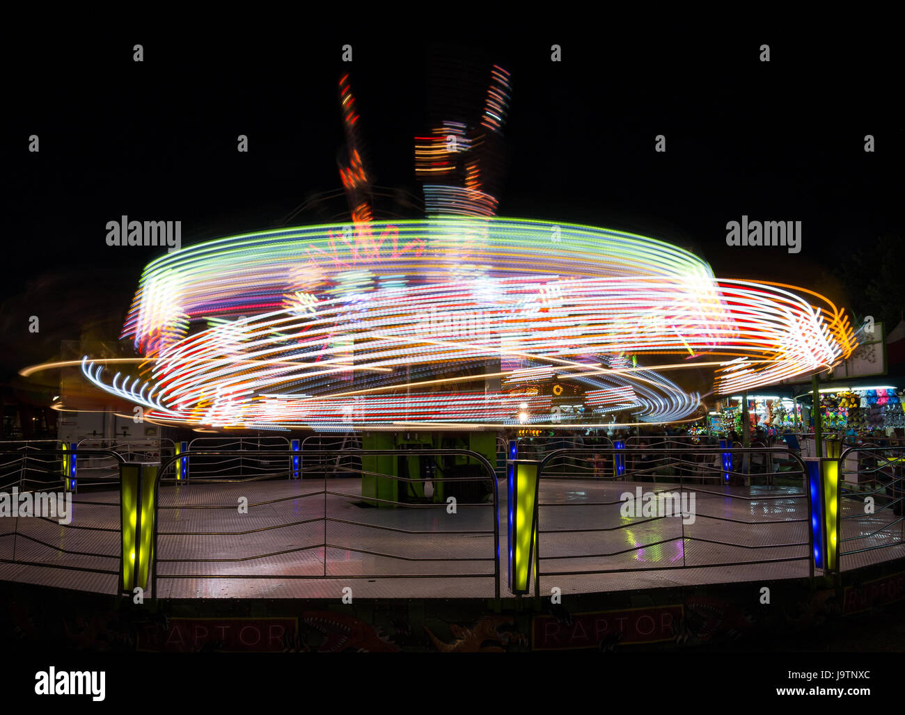 Popular rides at night at the county fair Stock Photo - Alamy