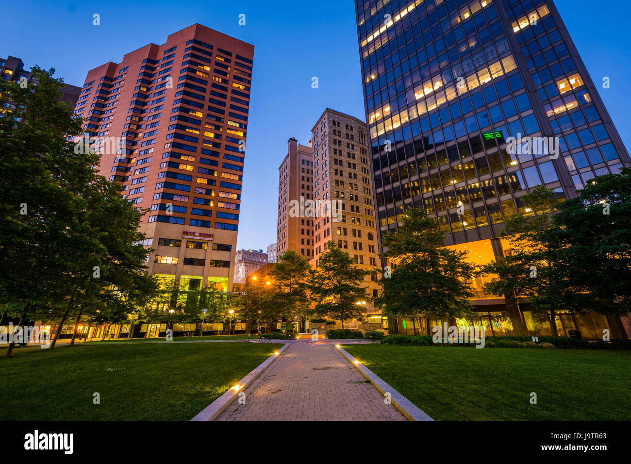 Walkway and buildings at Center Plaza at night, in downtown Baltimore ...