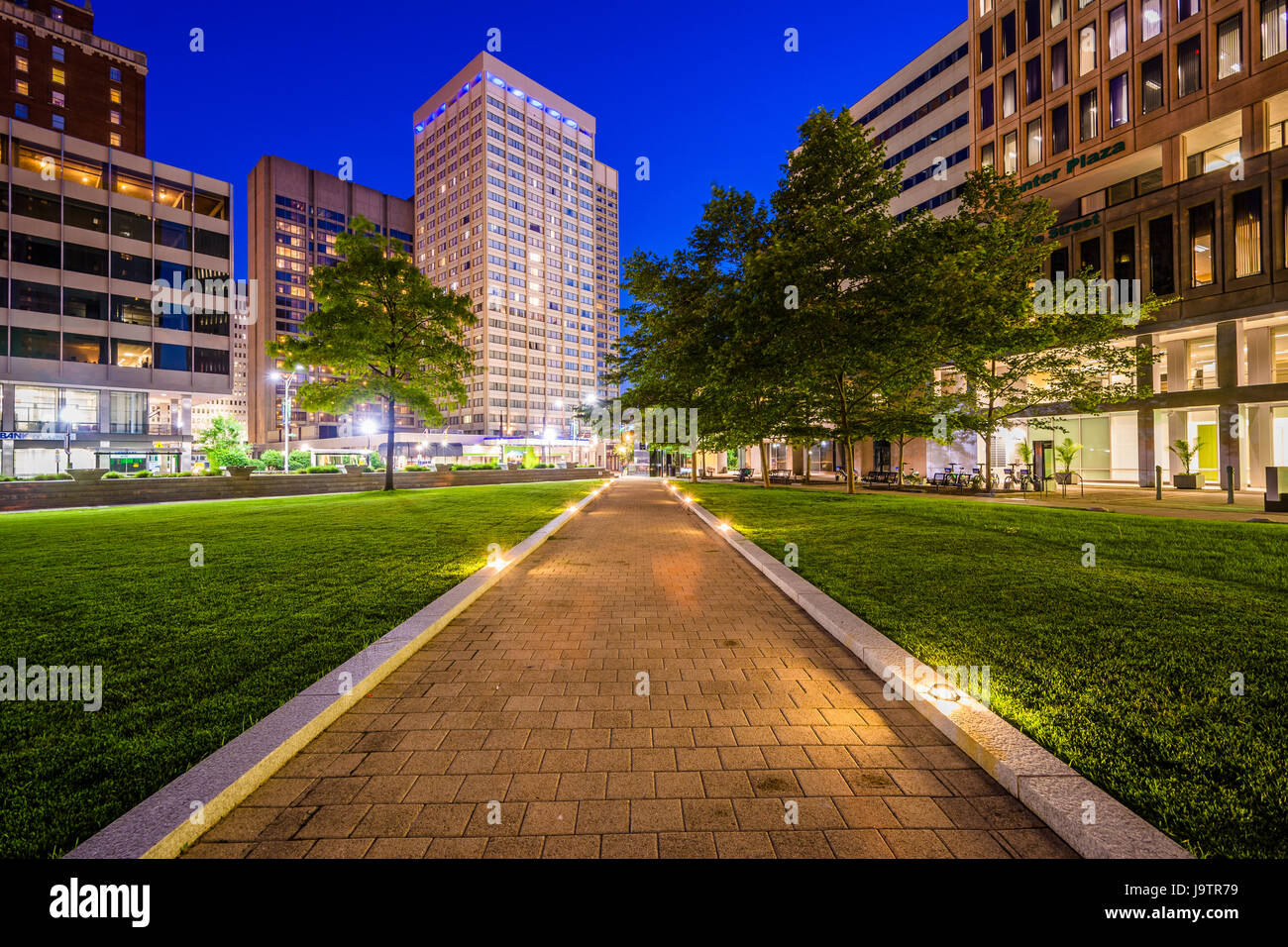 Walkway and buildings at Center Plaza at night, in downtown Baltimore ...