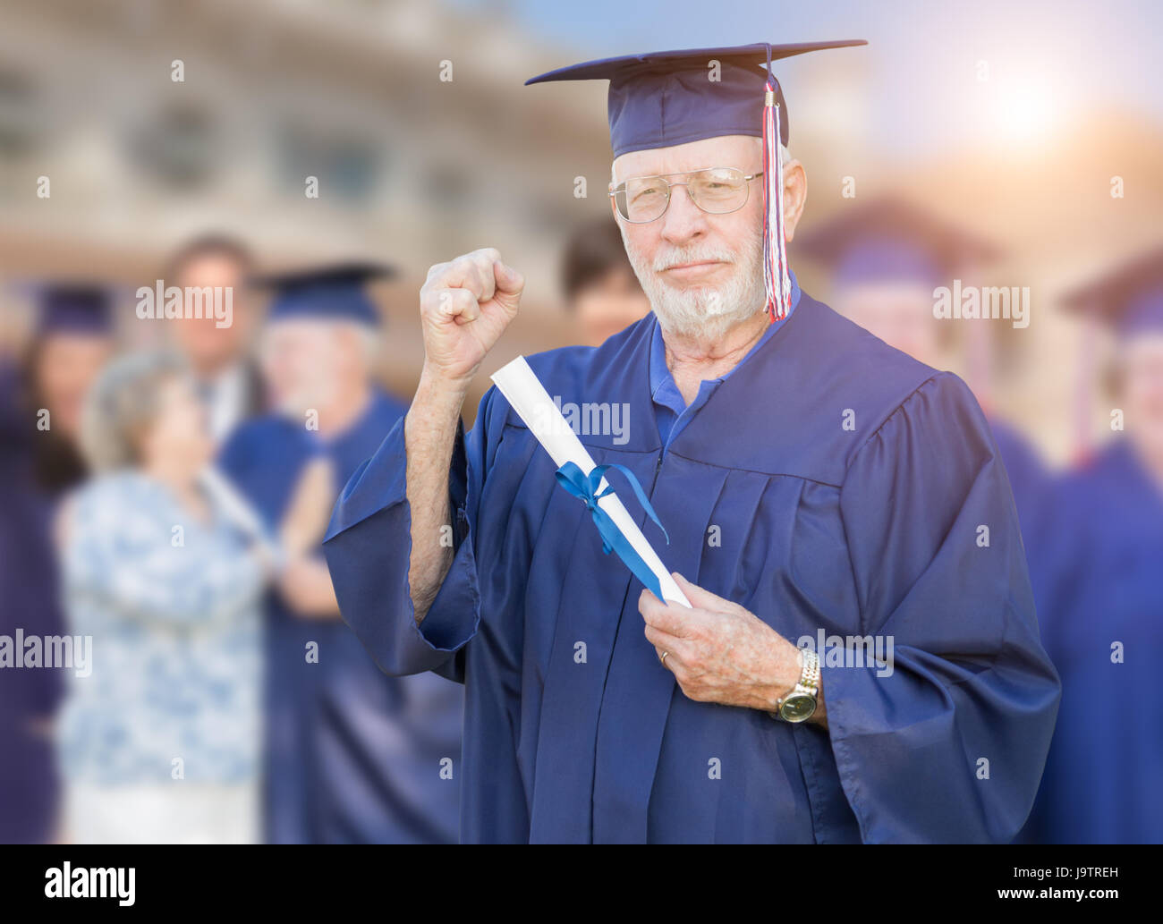 Proud Senior Adult Man In Cap and Gown At Outdoor Graduation Ceremony ...