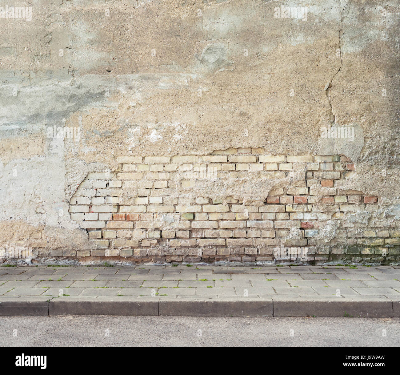 Urban background. Grunge obsolete street wall and pavement Stock Photo ...