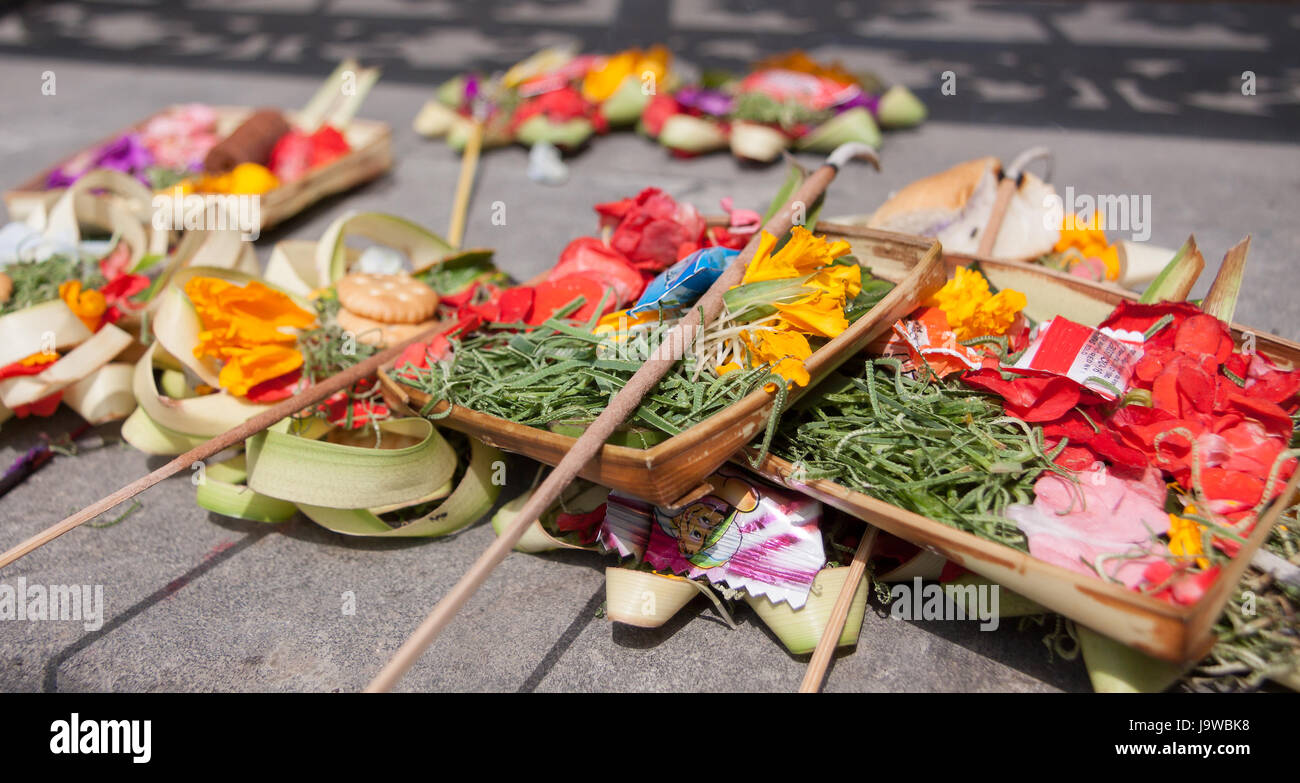 Traditional balinese offerings to gods with flowers and aromatic sticks ...