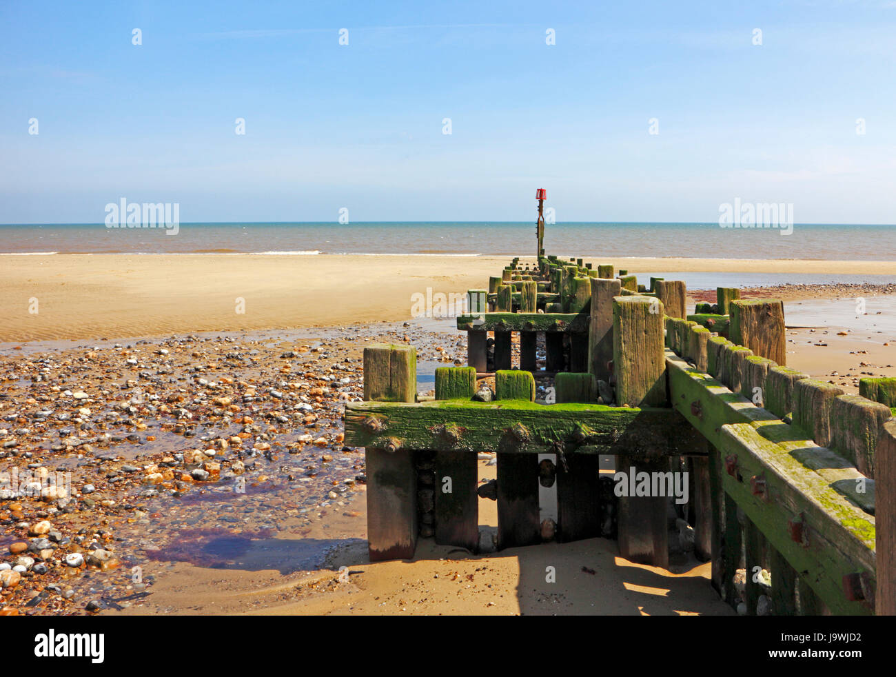 A view of a timber breakwater on the North Norfolk coast at Mundesley ...