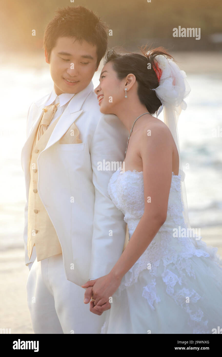 asian man and woman in wedding suit ceremony happy emotion at sea beach ...