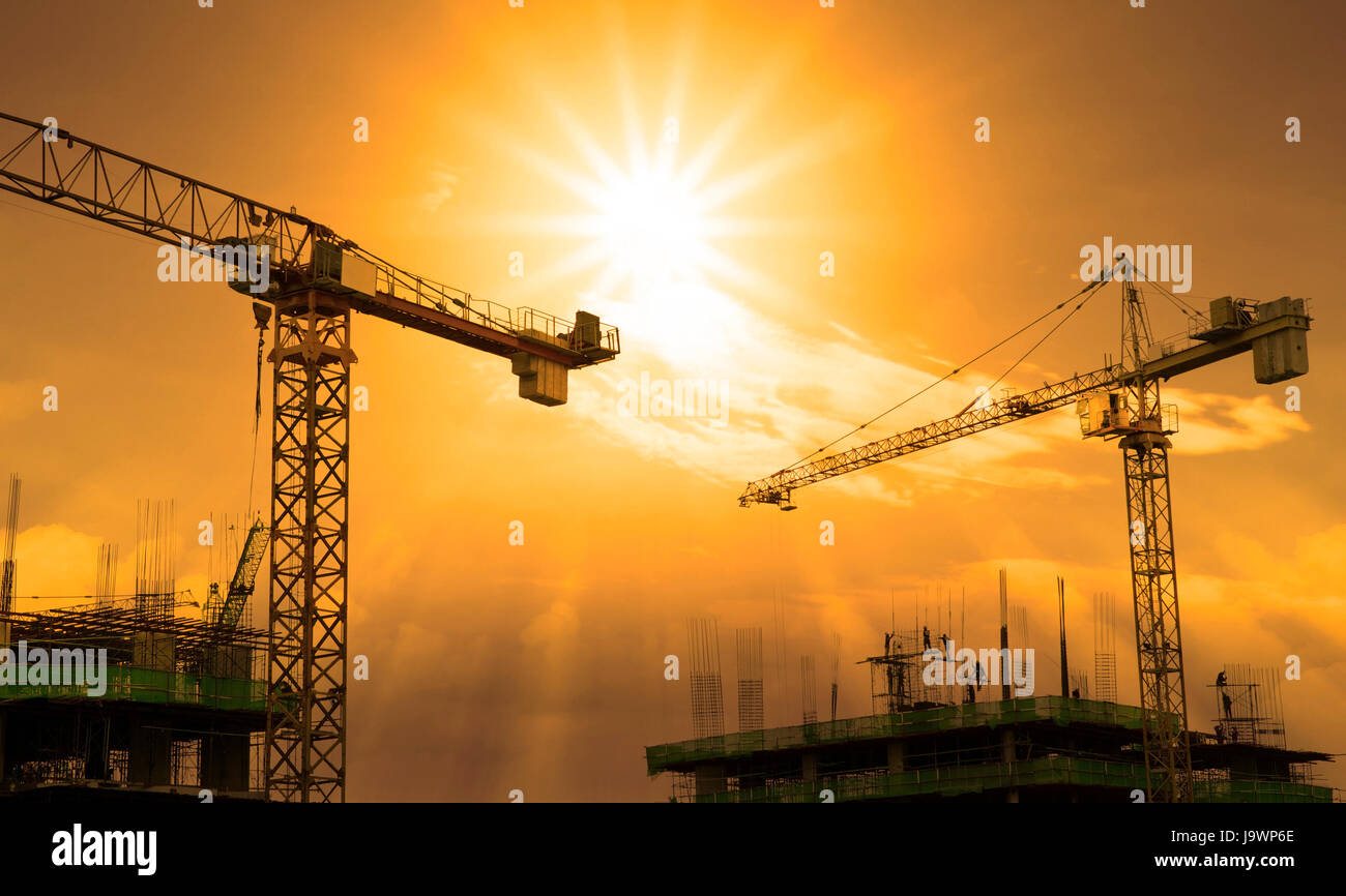crane and building construction and sun set sky Stock Photo - Alamy