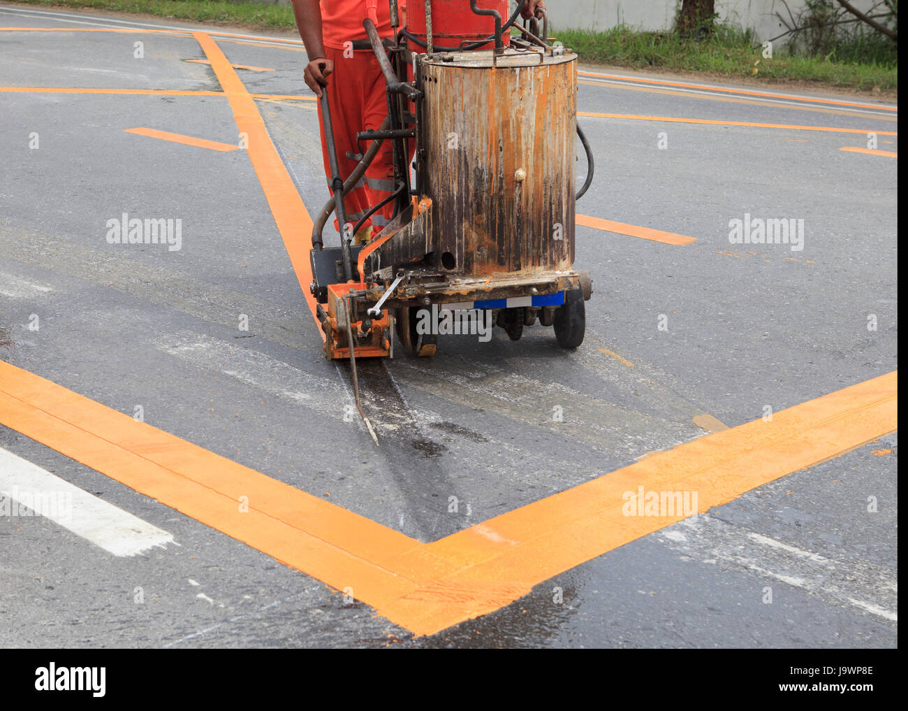 machine and worker at road construction use for road and traffic sign ...