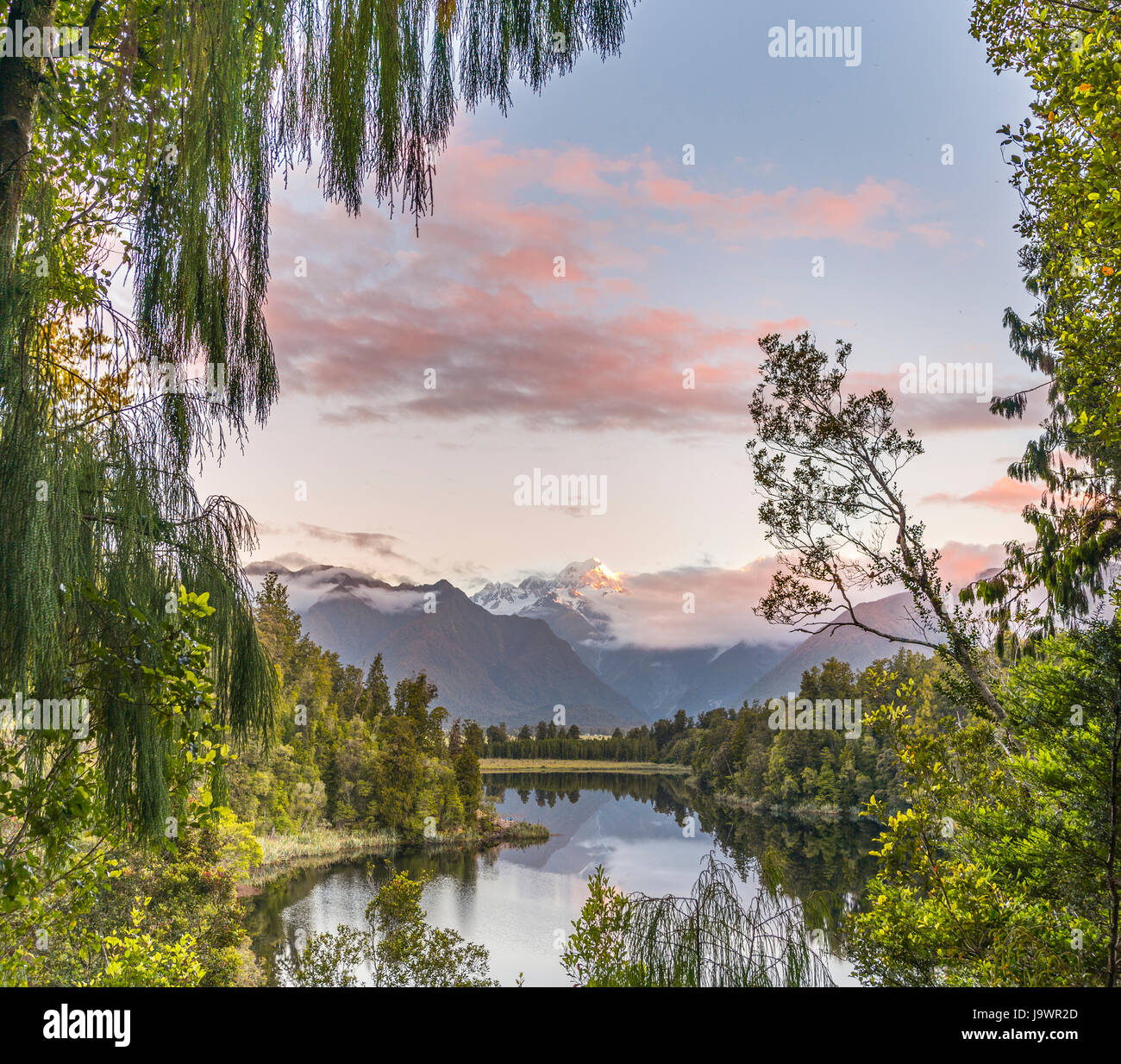 Sunset, view of Mt. Tasman and Mt. Cook, reflection in Lake Matheson ...