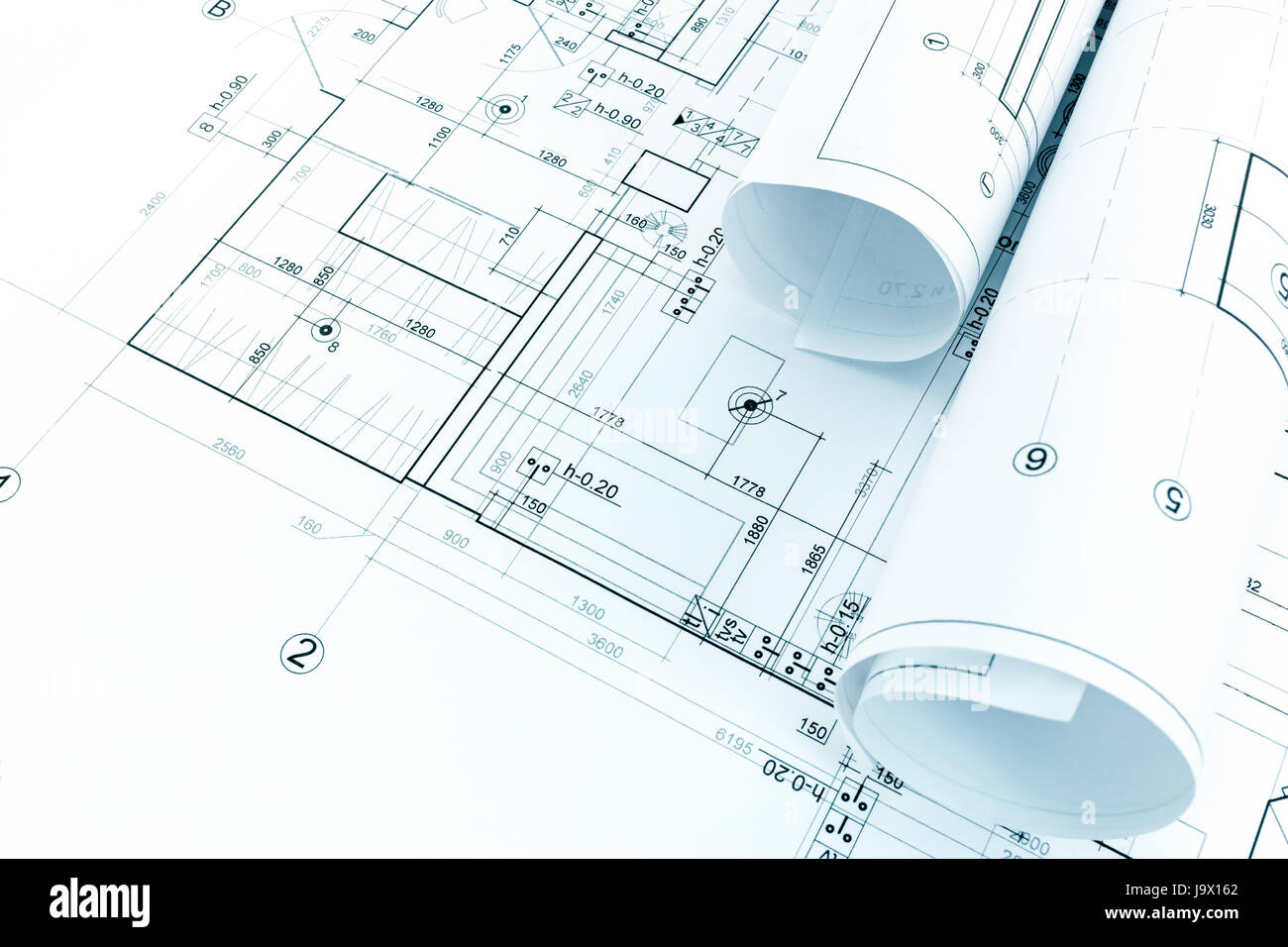 architectural interior project plan and rolls of blueprints on desk ...
