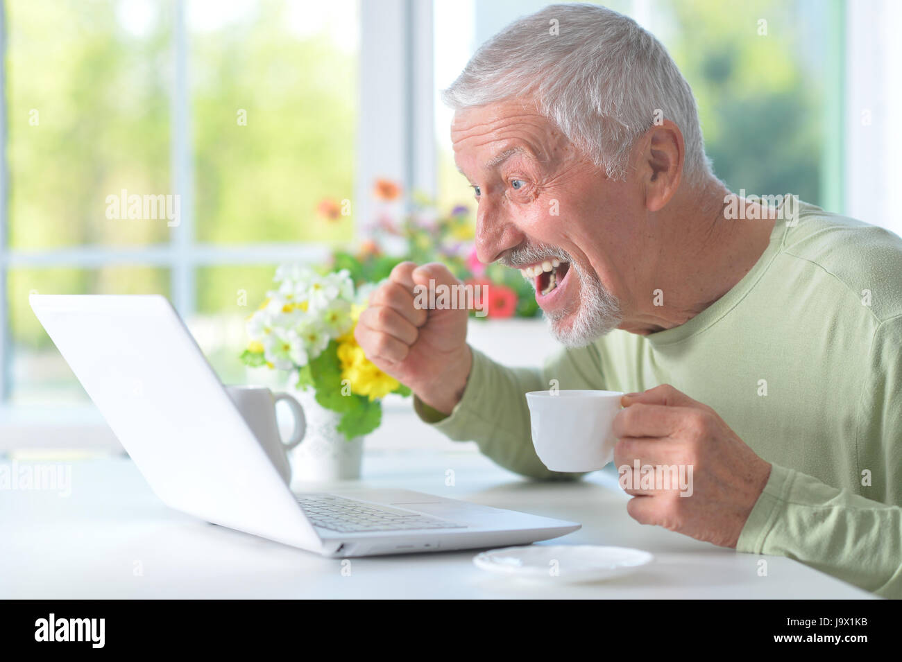 Beautiful old man with a laptop Stock Photo - Alamy