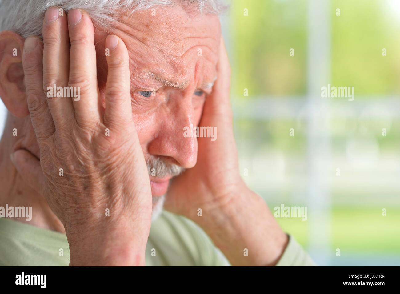 Old sad man on the window background Stock Photo - Alamy