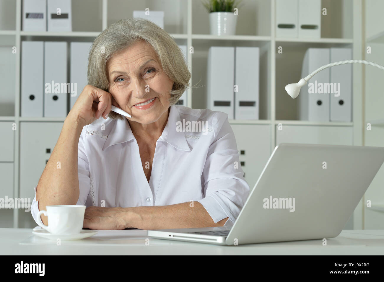 Old business woman with laptop working Stock Photo - Alamy