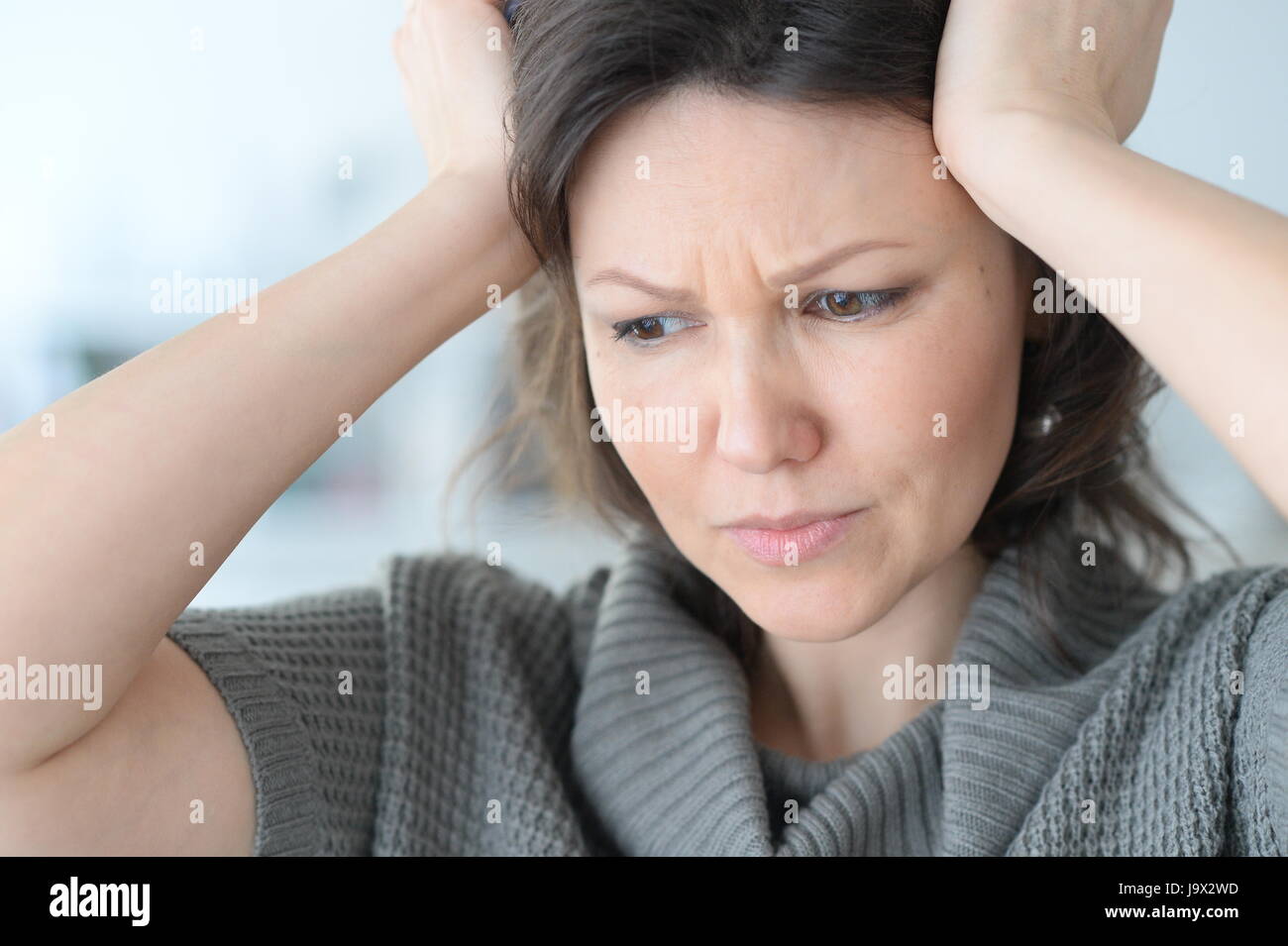Young woman with a headache Stock Photo - Alamy
