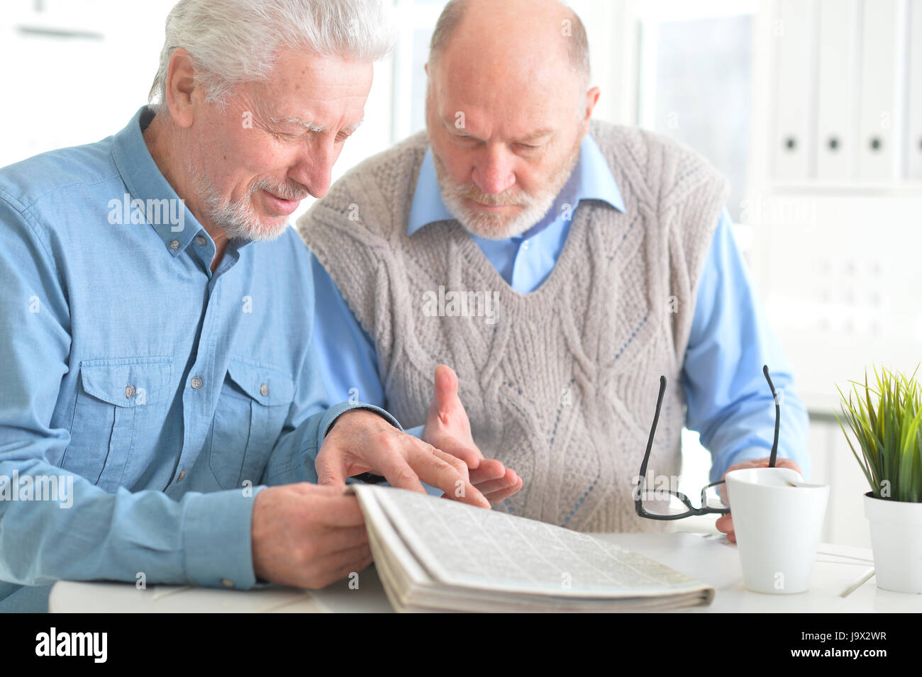 Old men reading a newspaper Stock Photo - Alamy