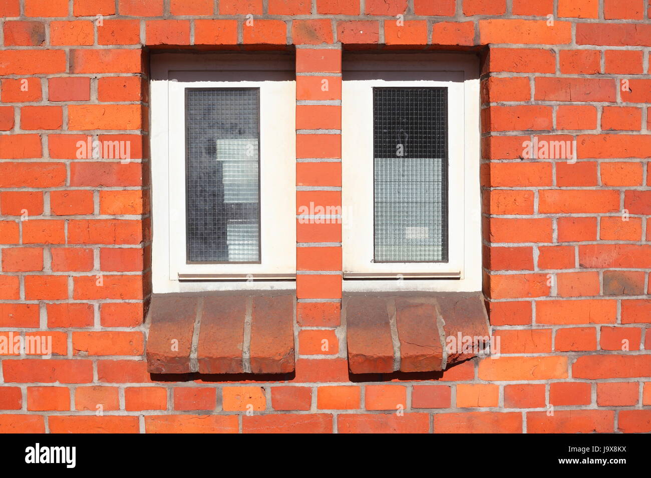 Small Windows on a Brick Wall Stock Photo - Alamy