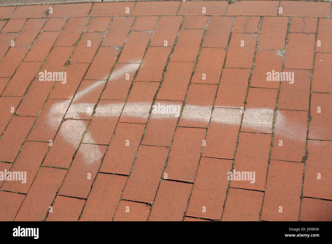 Ground mark white arrow Stock Photo - Alamy