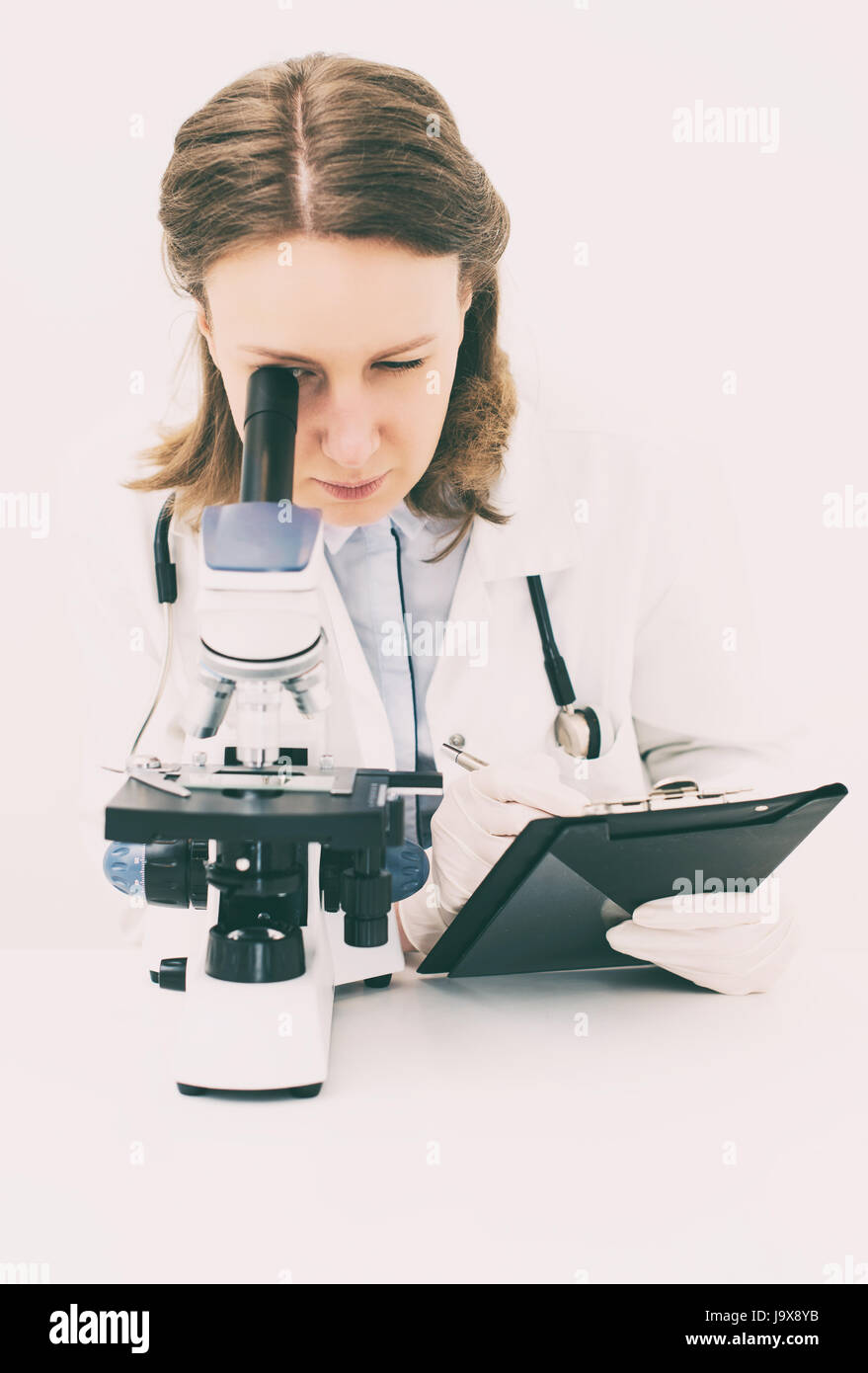 Doctor using microscope in laboratory. Space for text Stock Photo - Alamy