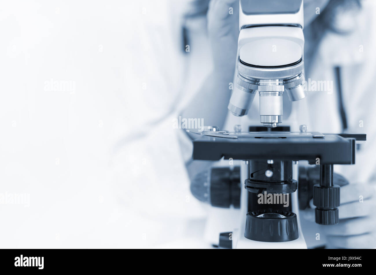 Scientist using microscope in laboratory Stock Photo - Alamy