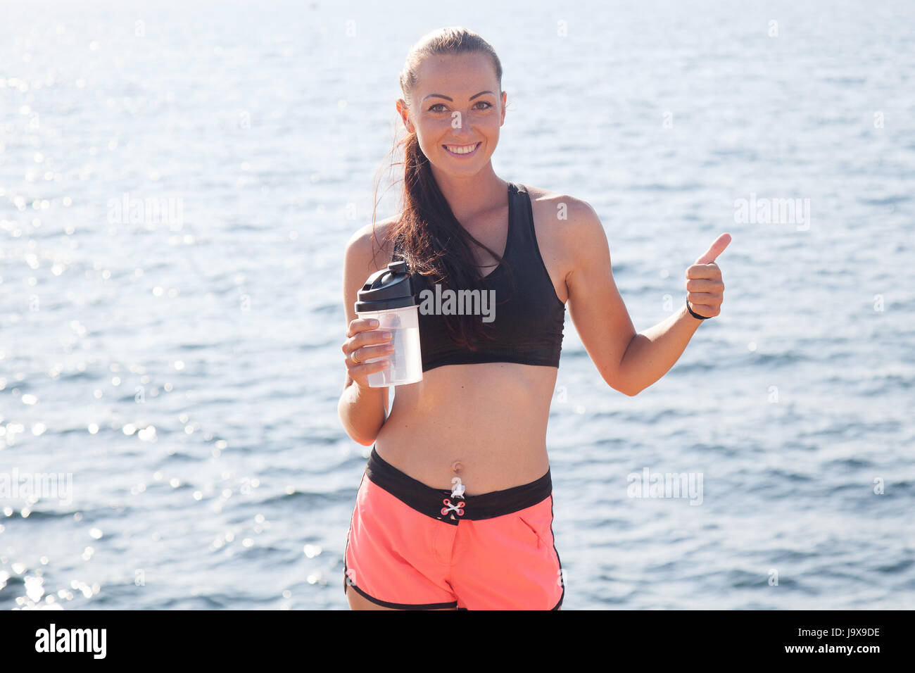girl drinks water after sports Stock Photo - Alamy