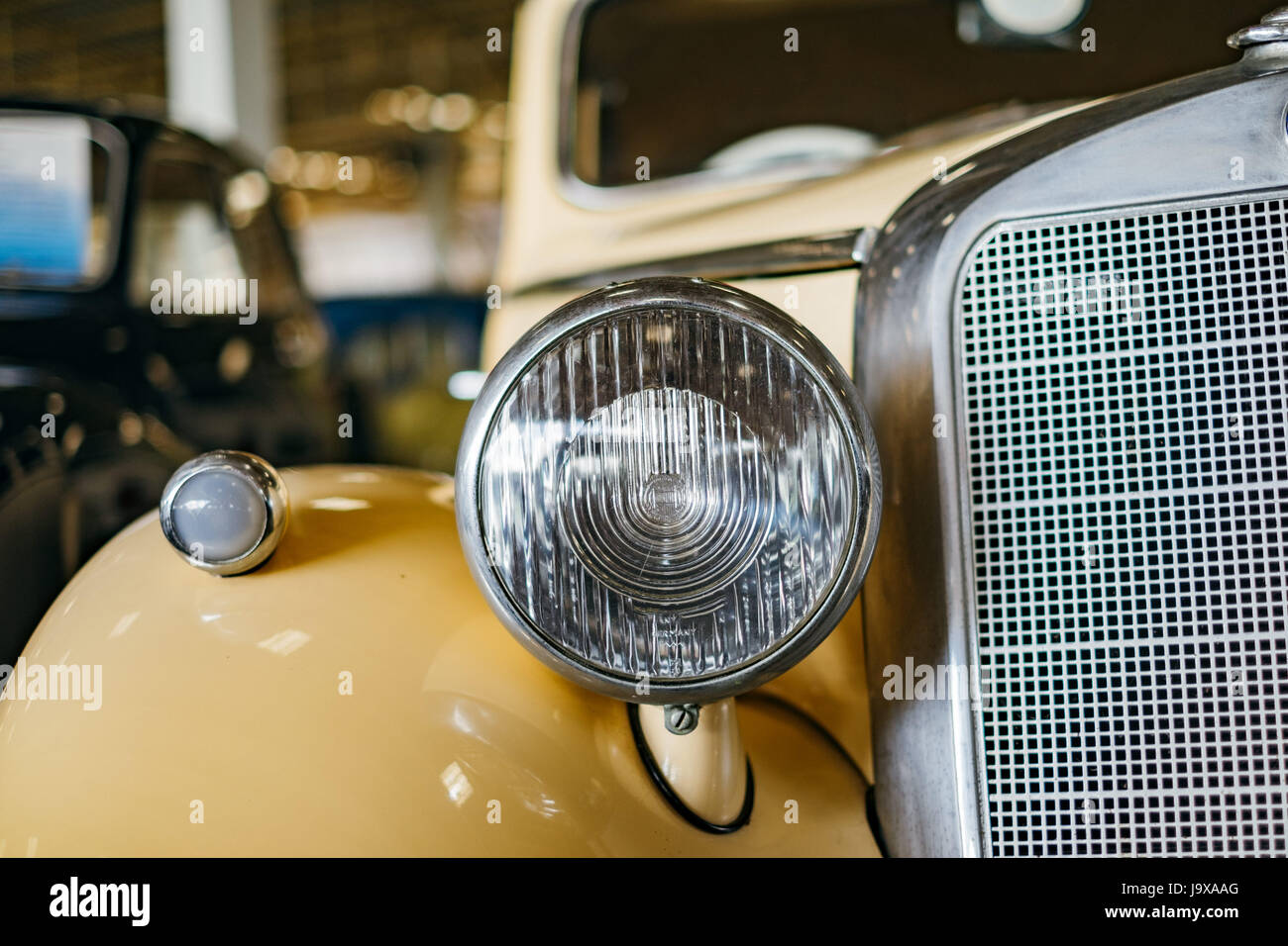 Headlight of the vintage cream car Stock Photo - Alamy